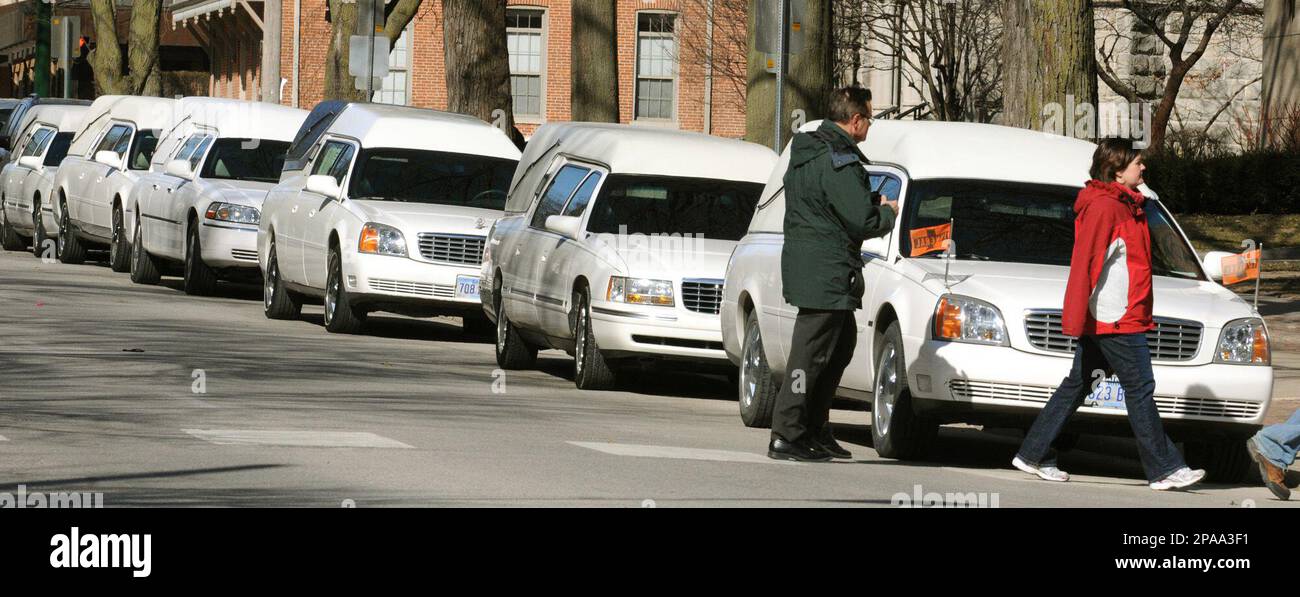 Mourners file past the six hearses lined up outside St. Mary's Church ...
