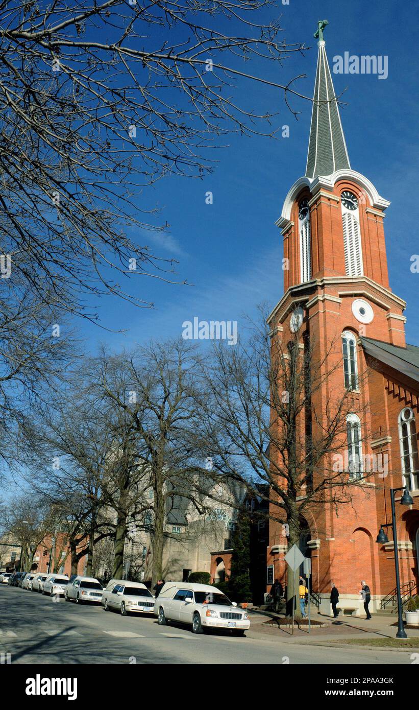 Mourners file past the six hearses lined up outside St. Mary's Church ...