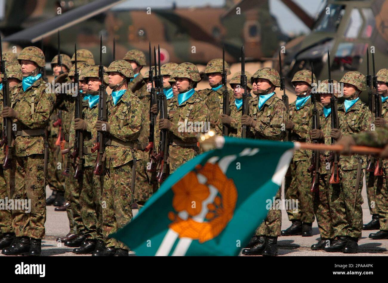 Japan Ground Self-Defense Force personnel stand at attention during the ...