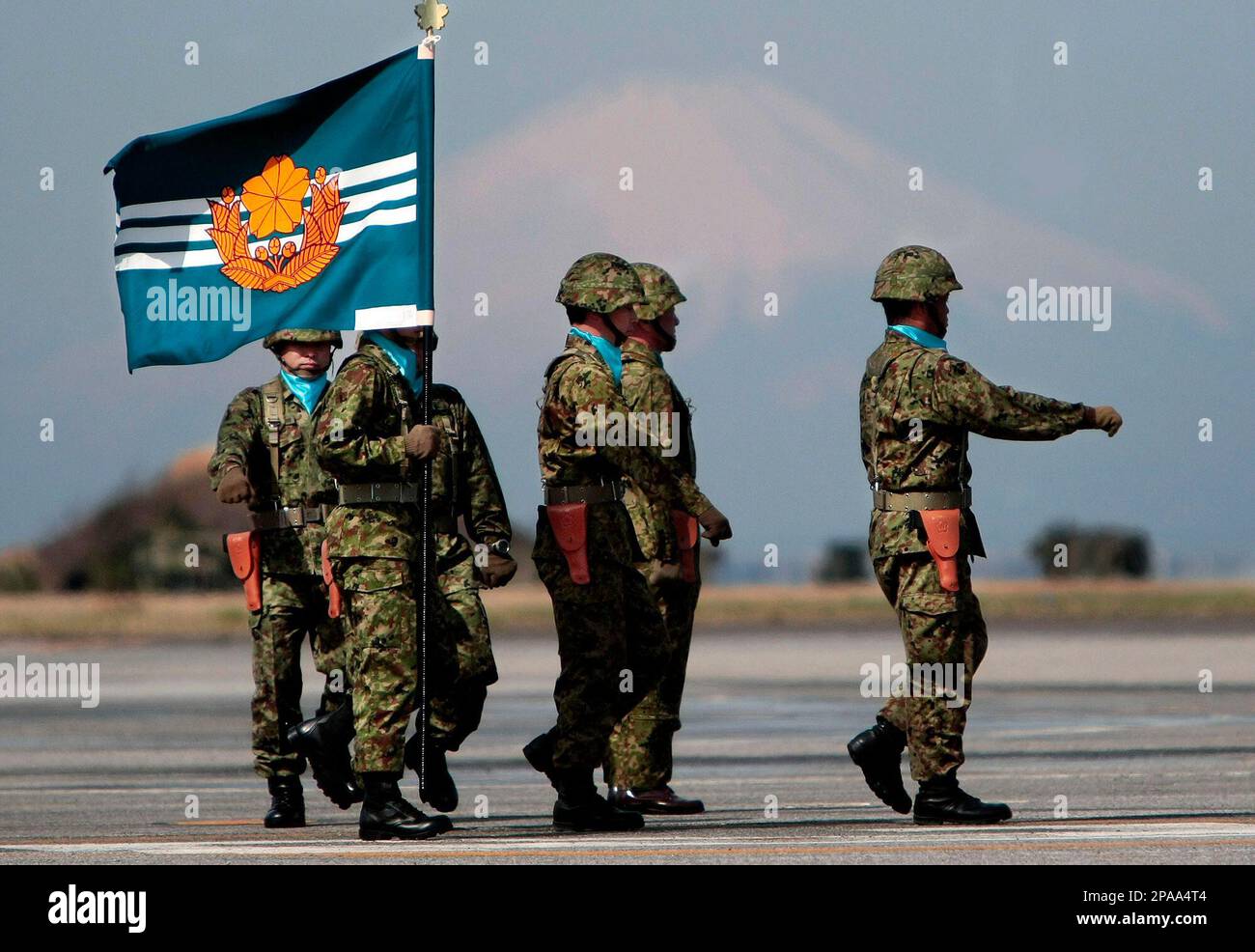 Japan Ground Self-Defense Force personnel march with a backdrop of Mt ...