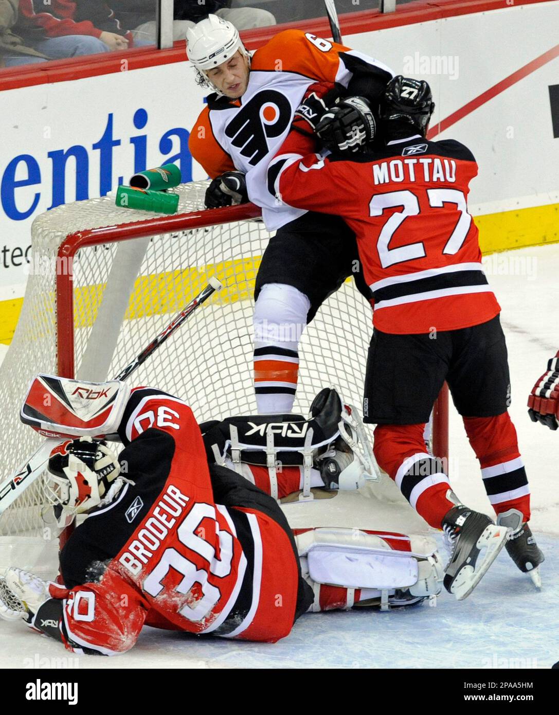 New Jersey Devils' Mike Mottau (27) shoves Philadelphia Flyers' Randy ...
