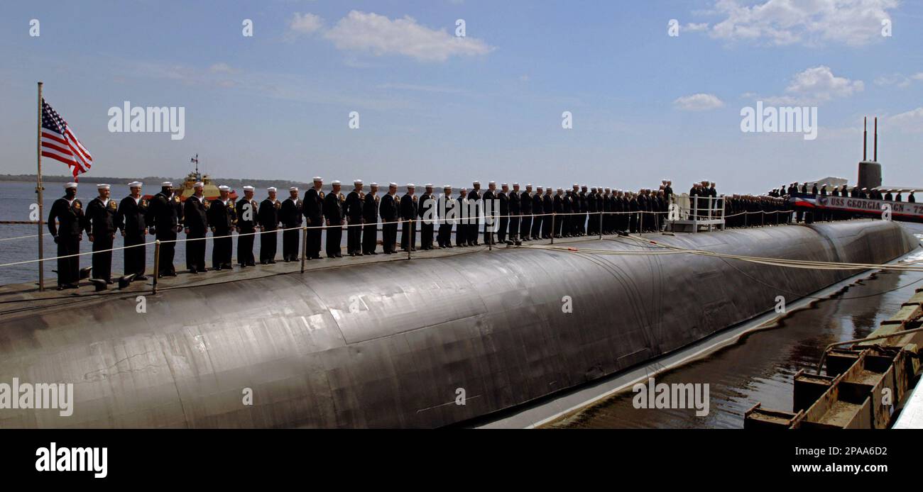 The crew of the U.S. Navy's nuclear-powered submarine USS Georgia stand at attention on the ...