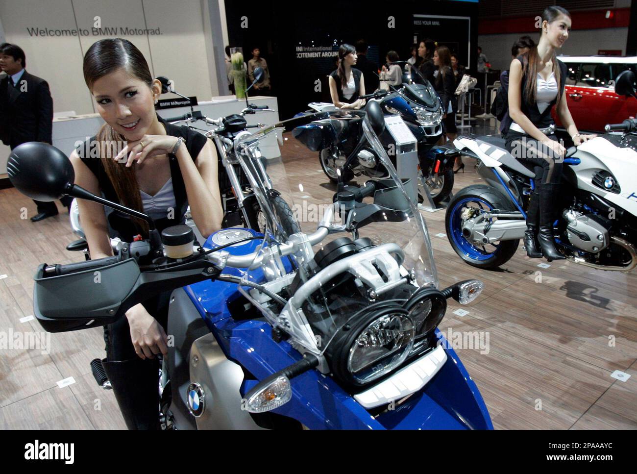Models pose on BMW motorcycles on display at Bangkok International ...