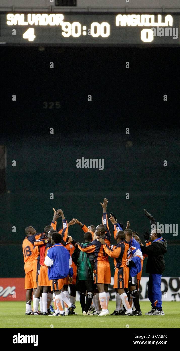 Members of Anguilla's soccer team gather on the field after their 4-0 ...