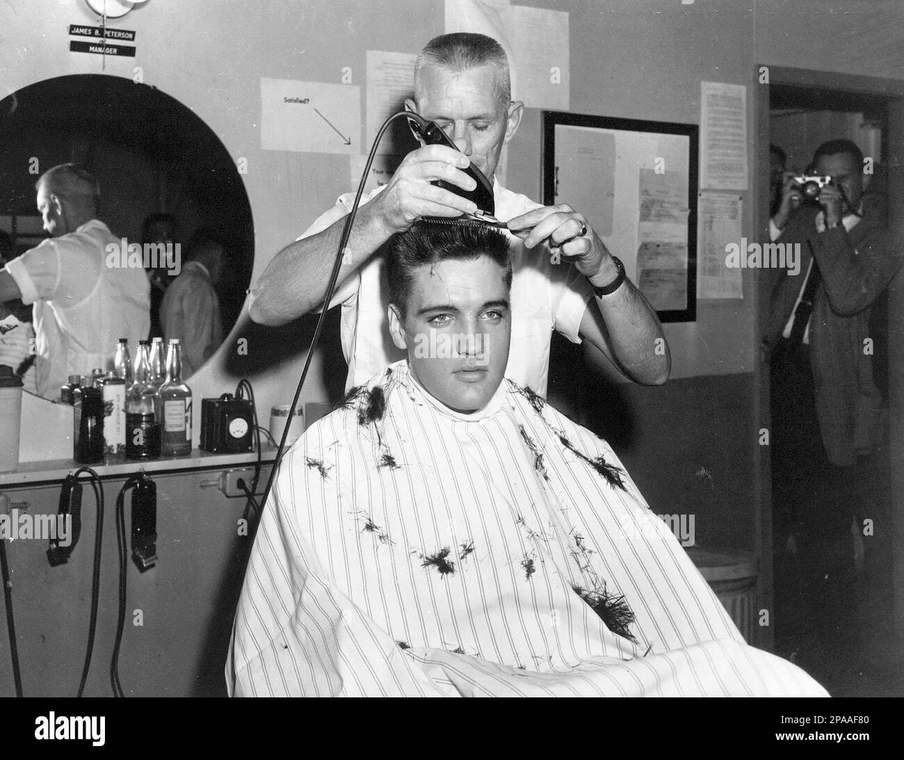 ** FILE ** In this March 1958 file photo, singer Elvis Presley gets his ...
