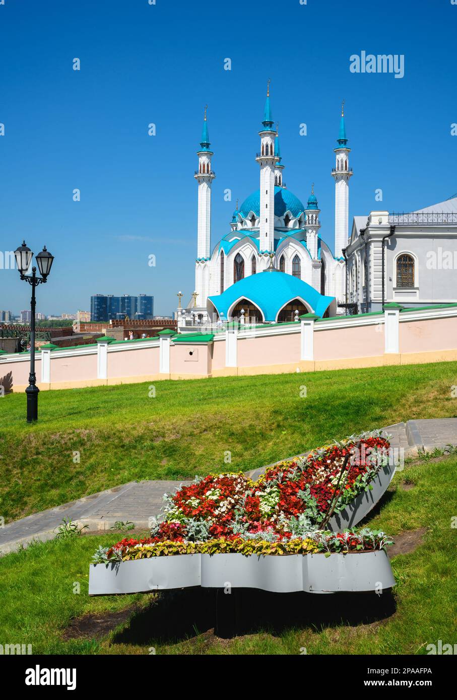 Flowerbed inside Kazan Kremlin, Tatarstan, Russia. Vertical view of Kul Sharif mosque in ...