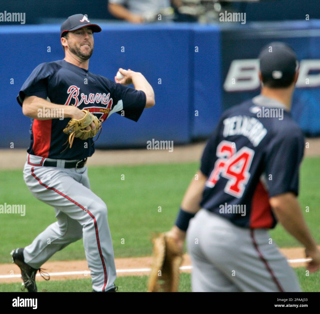 Atlanta Braves pitcher Jeff Ridgway, left, tries to throw out Cleveland ...