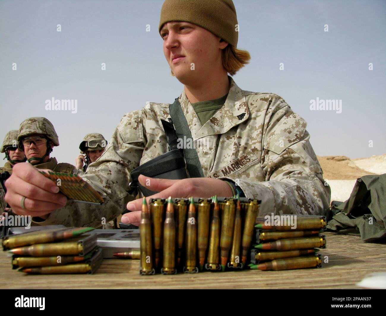 A U.S. Marine loads ammunition at a firing range inside the al-Asad Air ...