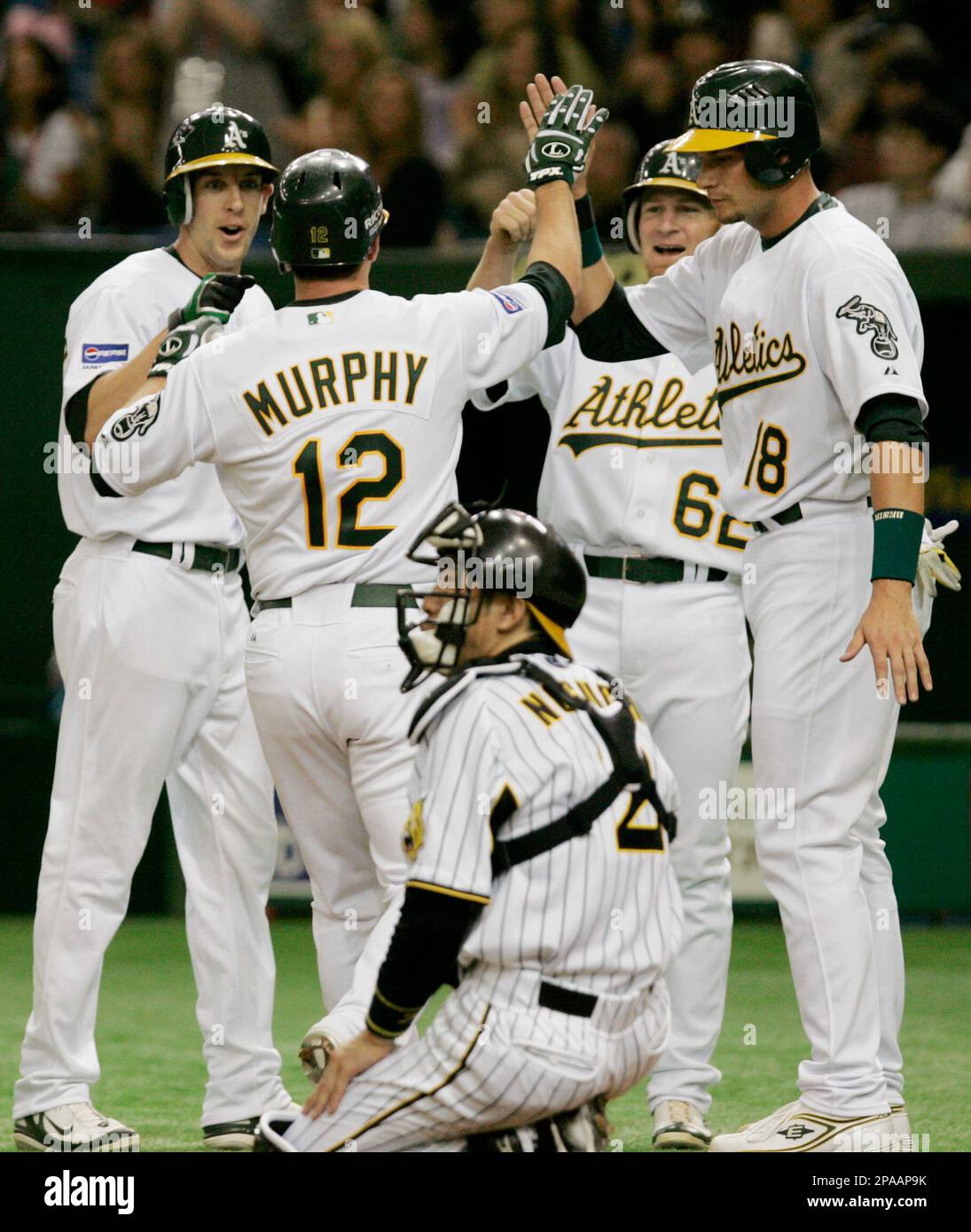 Oakland Athletics utilityman Donnie Murphy (12) is congratulated by ...