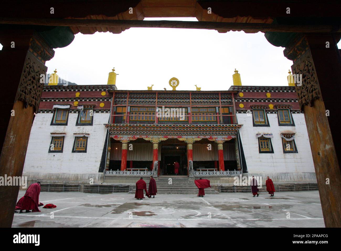 Tibetan monks arrive for prayers at the Dongzhuling Monastery in the ...