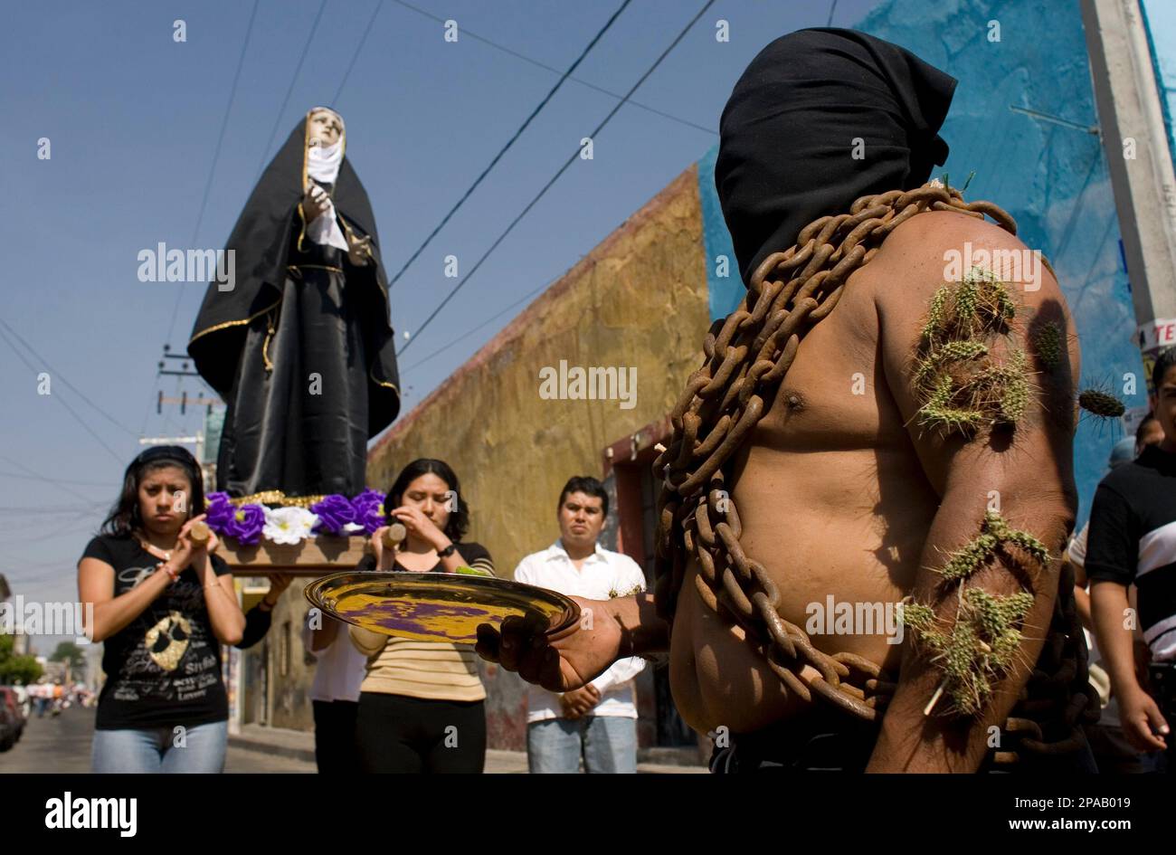 A penitent, wearing chains and cactus stuck on their flesh, right ...
