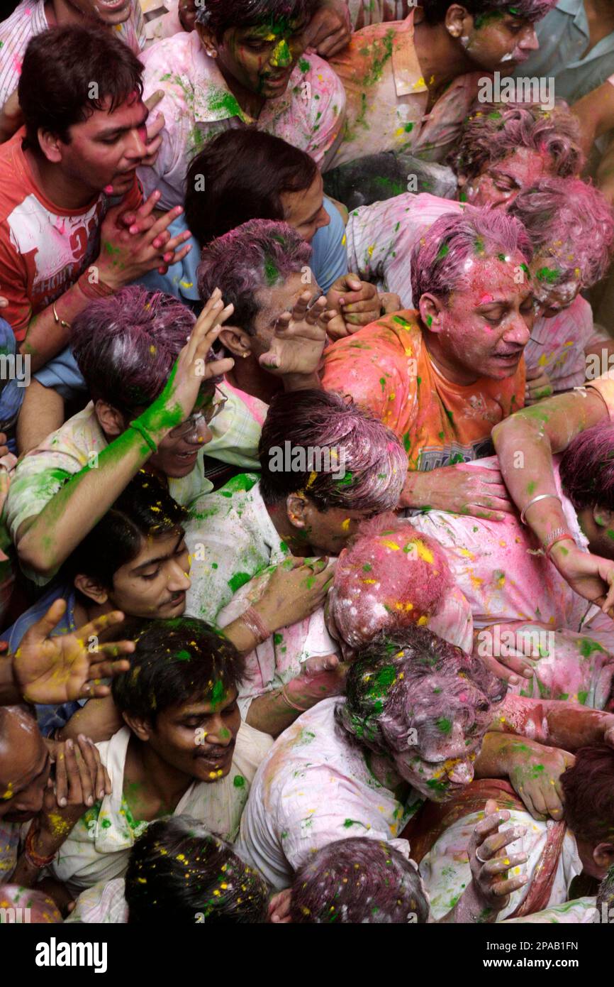 People smear colored powder as they celebrate 'Holi', the spring ...