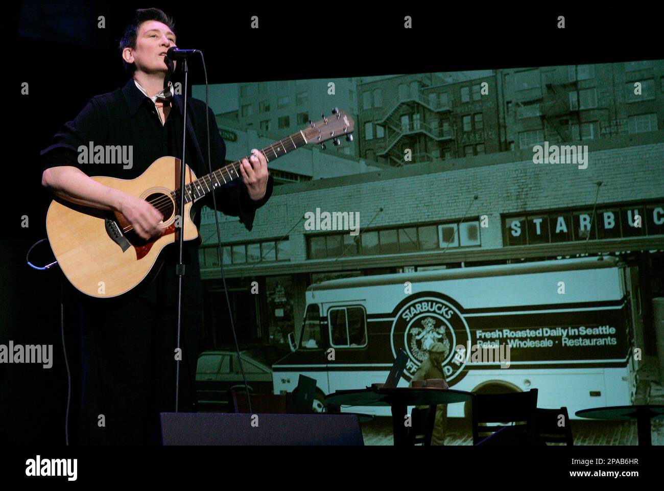 Singer k.d. Lang performs in front of an historic photo of the first ...
