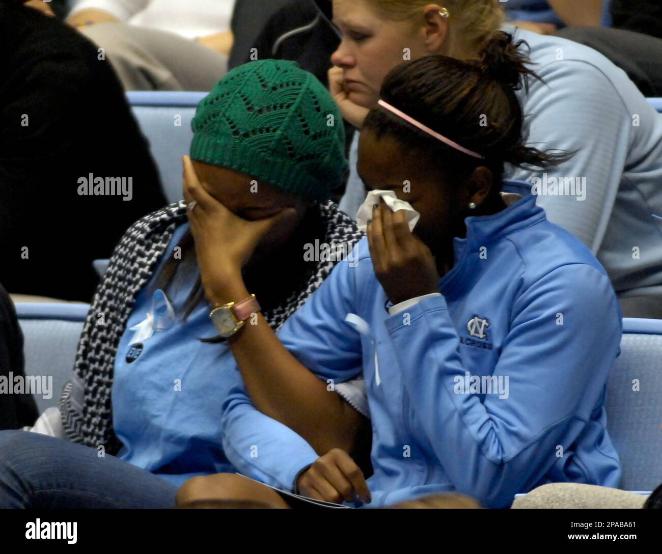 University of North Carolina lacrosse players cry during the memorial ...