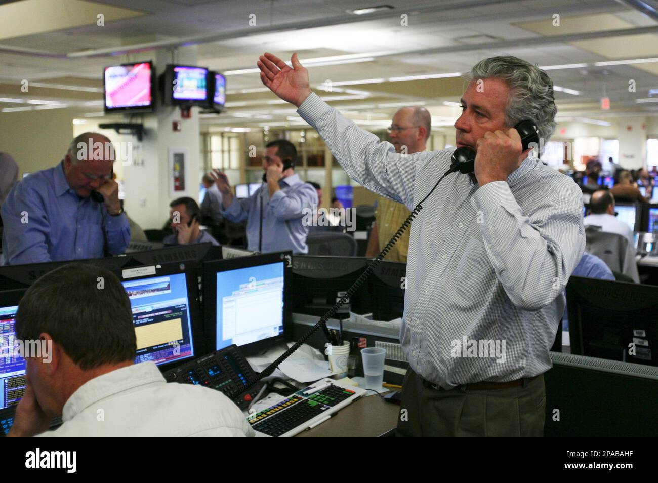 Brokers work on the trading desk at ICAP following the Federal Reserve ...