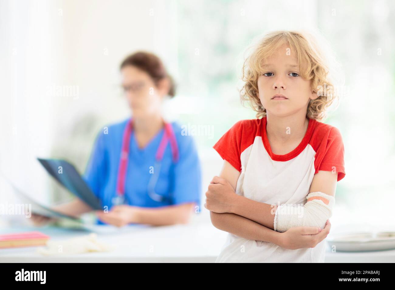 Child with arm injury at trauma and emergency care. Kid with elbow cast ...