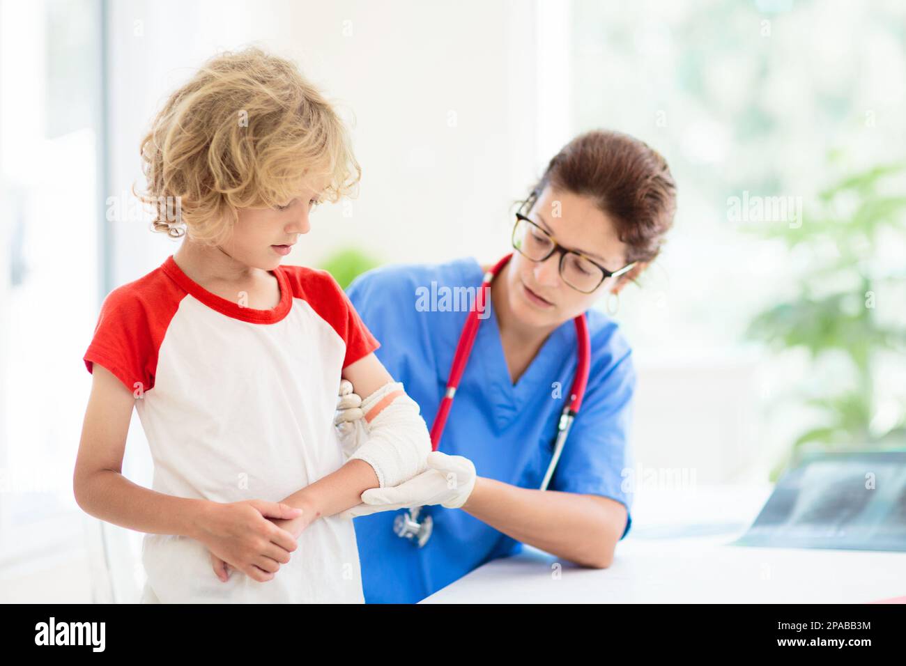 Child with arm injury at trauma and emergency care. Kid with elbow cast ...