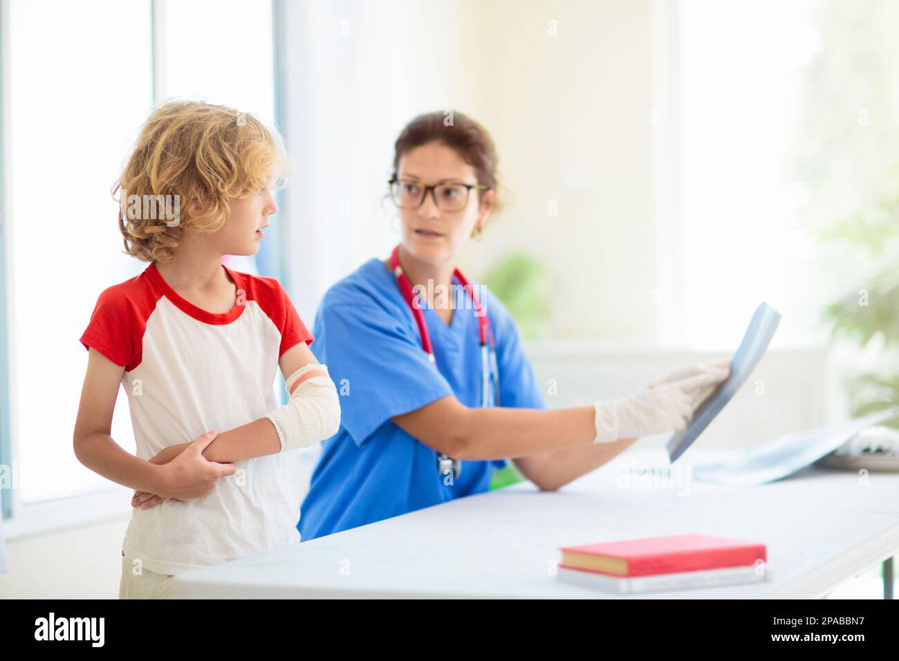 Child with arm injury at trauma and emergency care. Kid with elbow cast ...