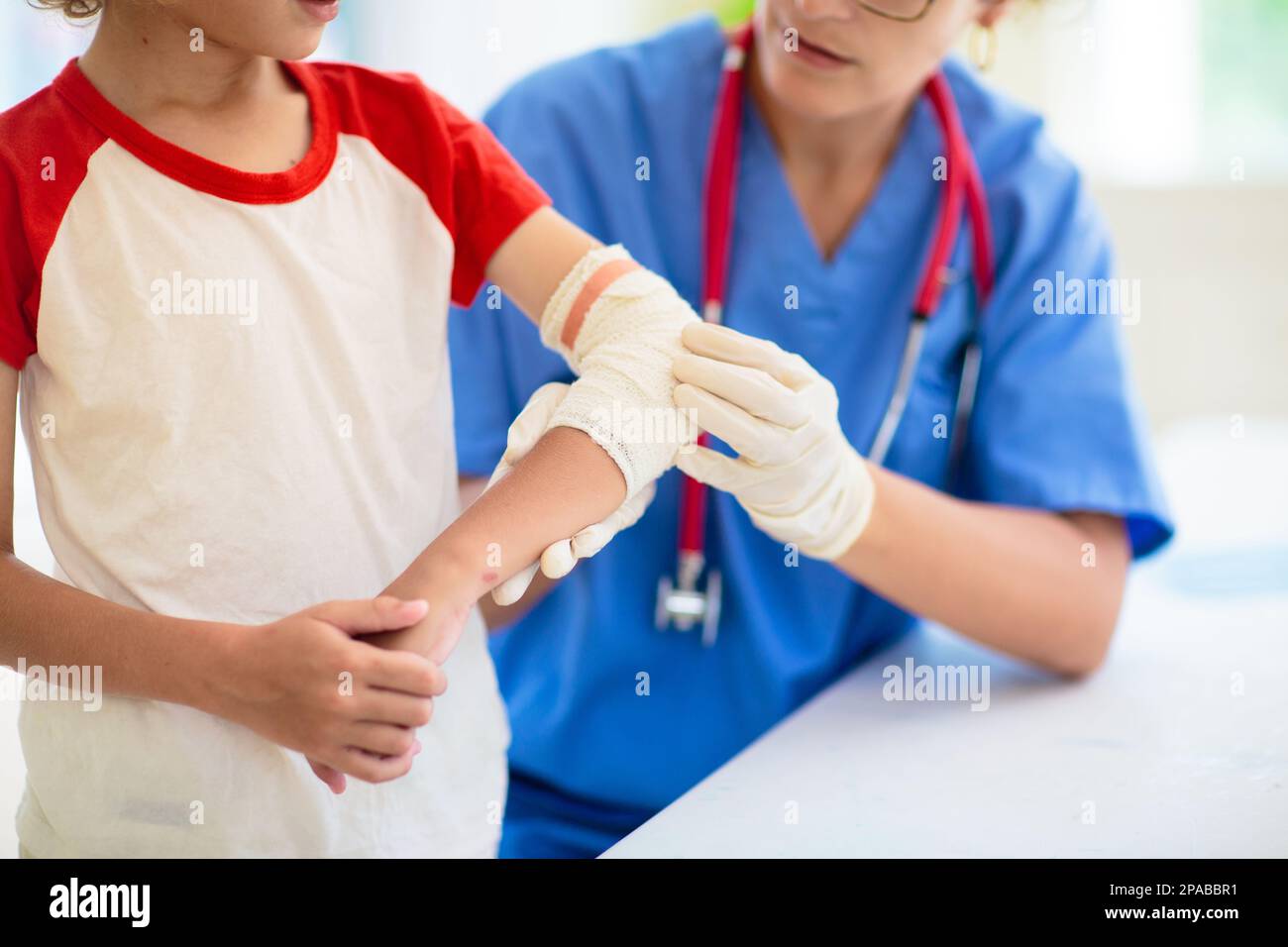Child with arm injury at trauma and emergency care. Kid with elbow cast ...