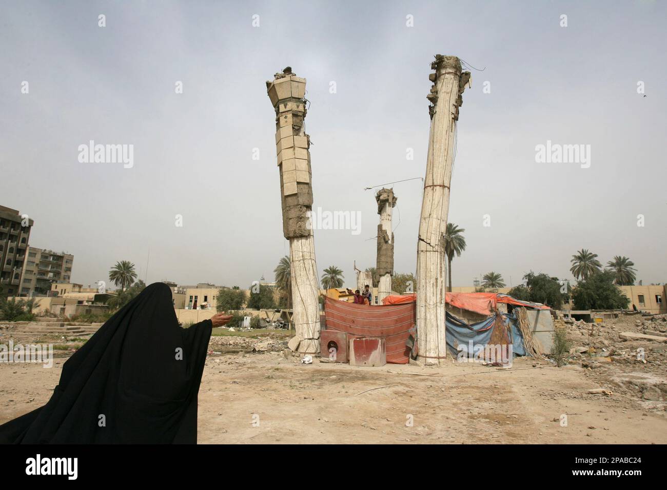 Iraqi woman walks to her makeshift home inside the former Iraqi army ...