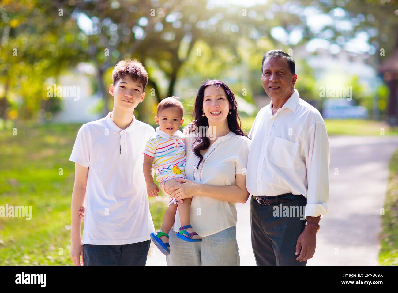 Family walking in summer park. Parents and kids outdoor. Mother, father ...
