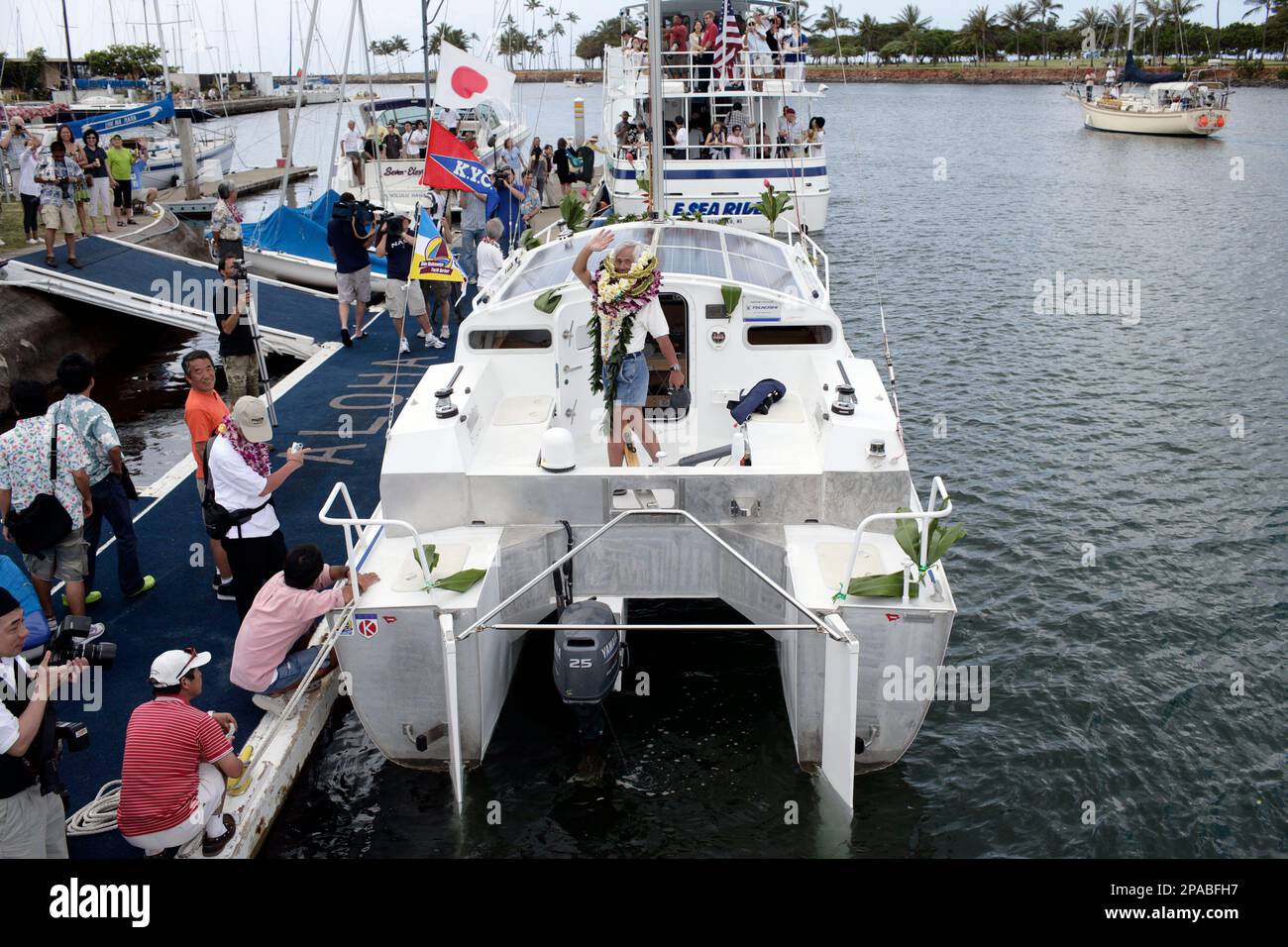 Ken-ichi Horie, of Japan, stands aboard his wave powered boat, the ...