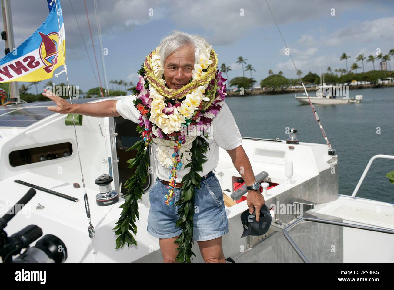 With Hawaiian lei around his neck, Ken-ichi Horie, of Japan, stands ...
