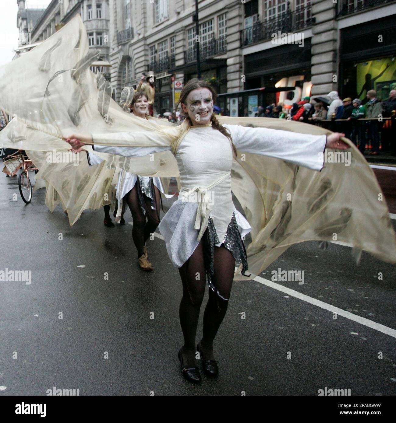 Revellers dance as they parade through central London during the St ...