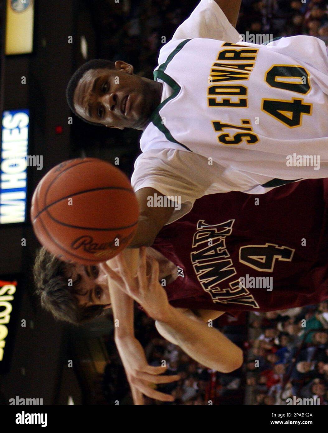 Newark's Dane Kopp (4) and Lakewood St. Edward's Andre Eanes (40) go ...