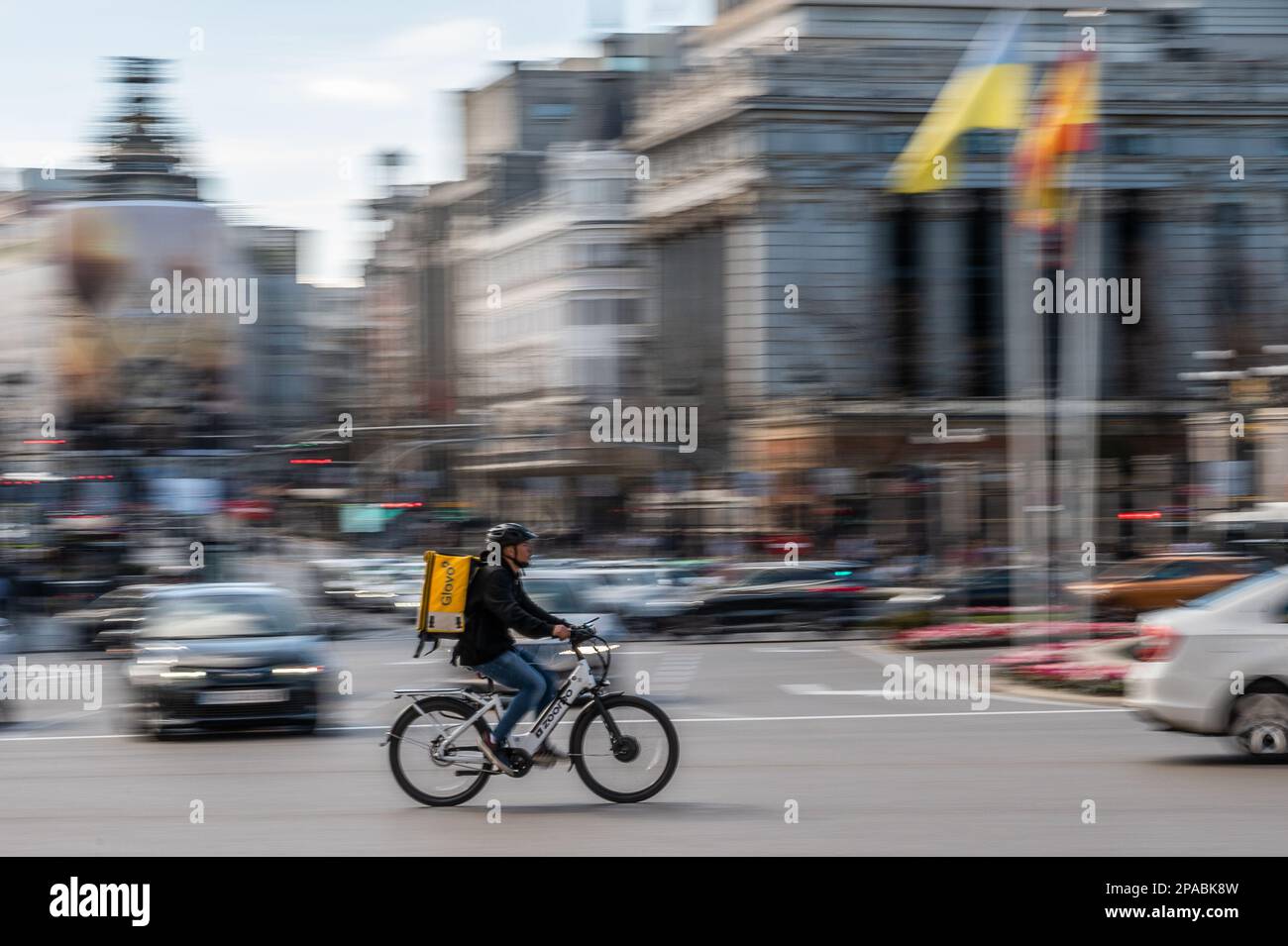 A courier for the food delivery service Glovo is seen riding a bike ...