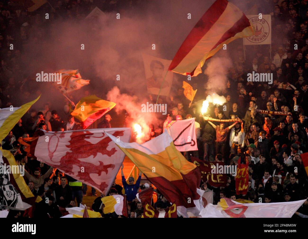 AS Roma supporters light flares and wave flags prior to the start of ...