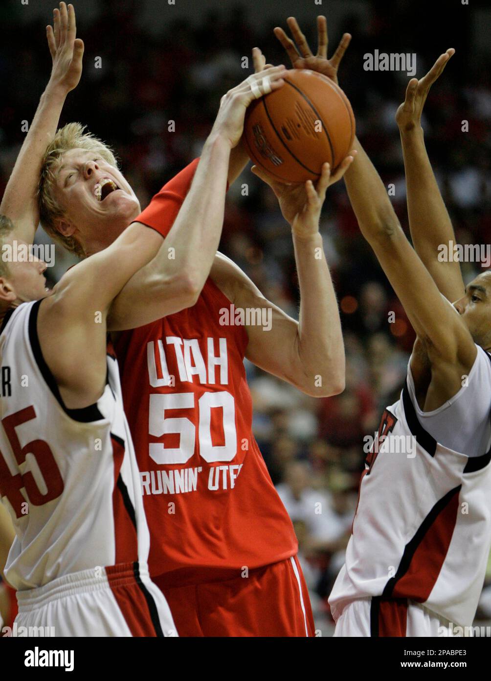 Utah's Luke Nevill is guarded by UNLV's Joe Darger, left, and Rene ...