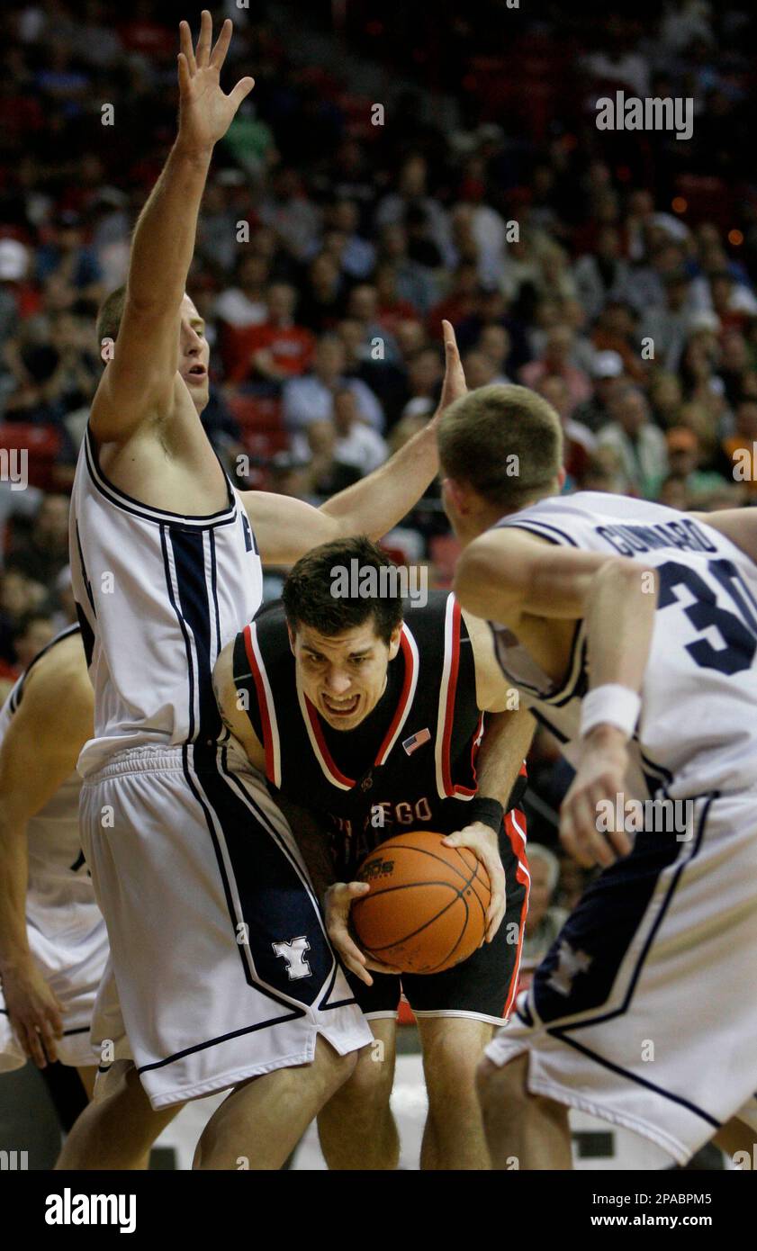 San Diego State's Ryan Amoroso tries to shoot through BYU's Chris Miles ...