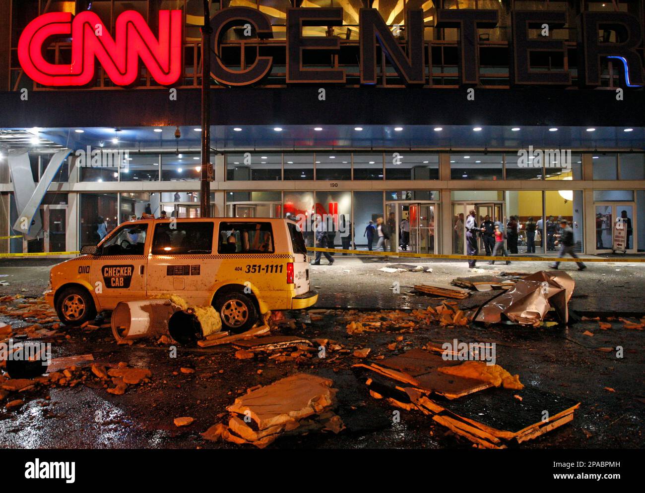 People walk through the debris in front of CNN Center in downtown ...