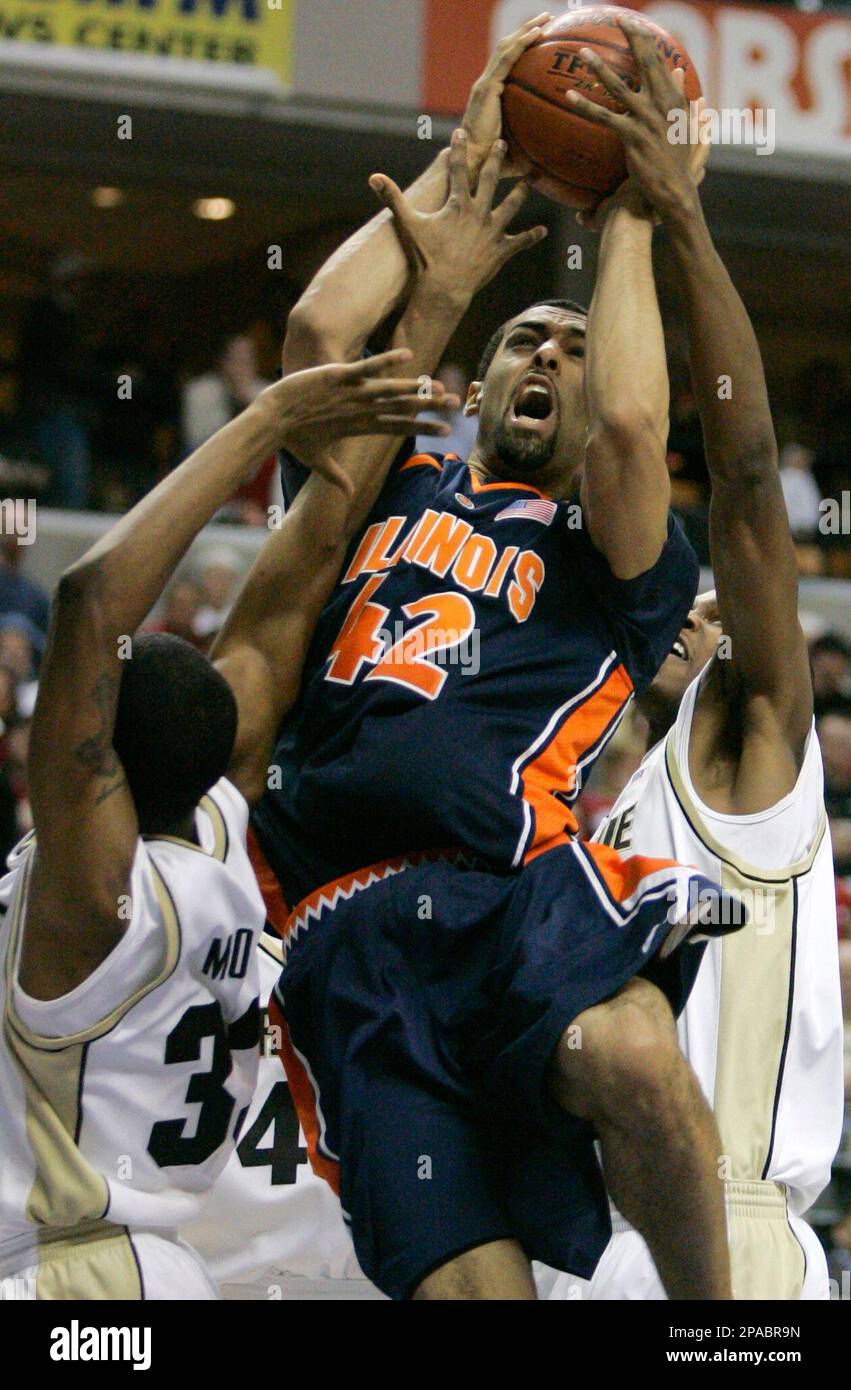 Illinois forward Brian Randle (42) gets double-teamed by Purdue guards ...