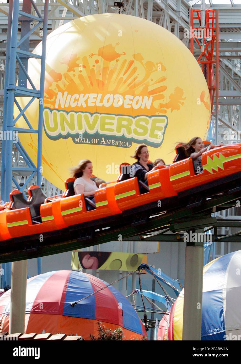 Roller-coast riders zip by on the Pepsi Orange Streak at the Mall of ...