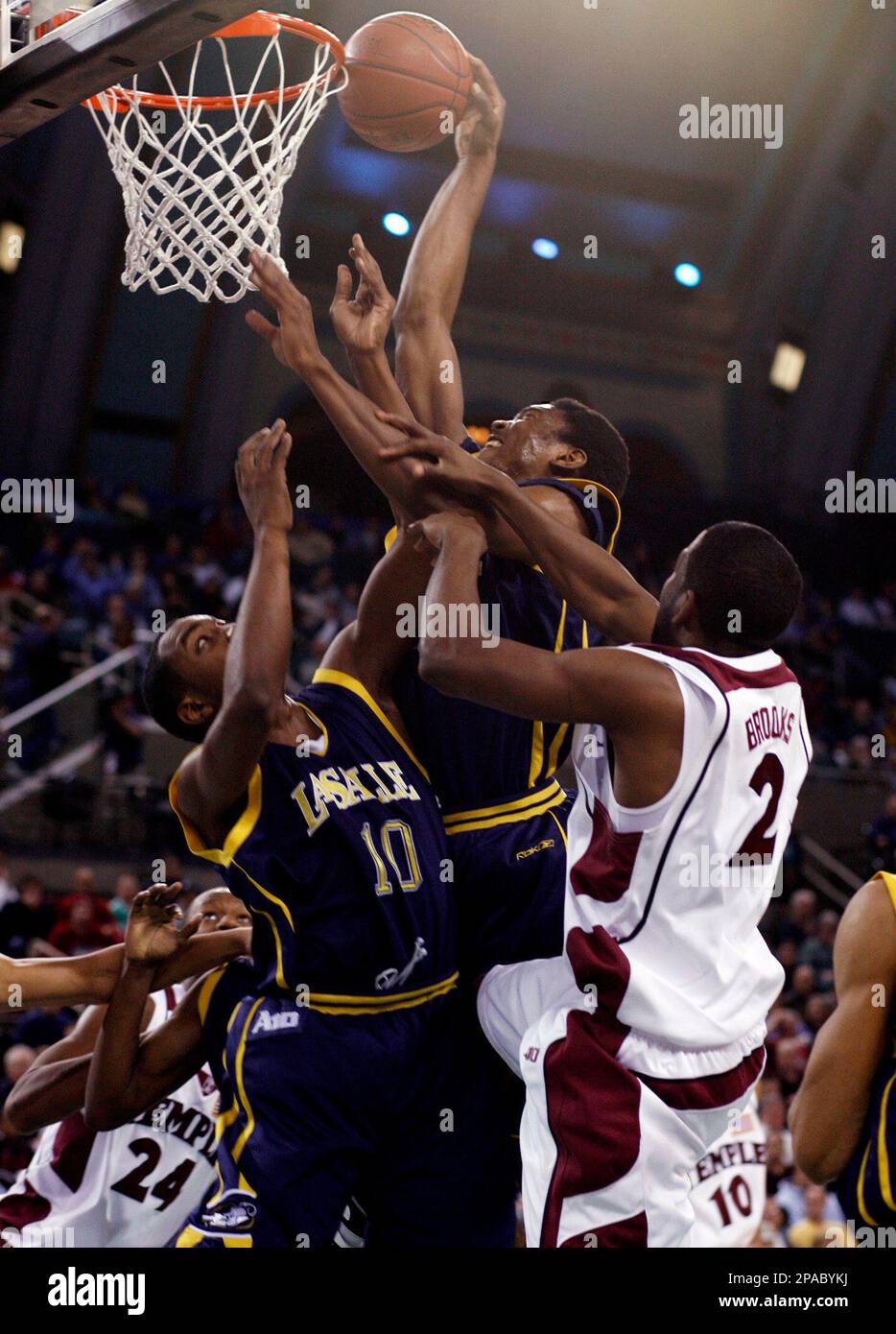 La Salle's Yves Mekongo Mbala, center, grabs a rebound as teammate ...