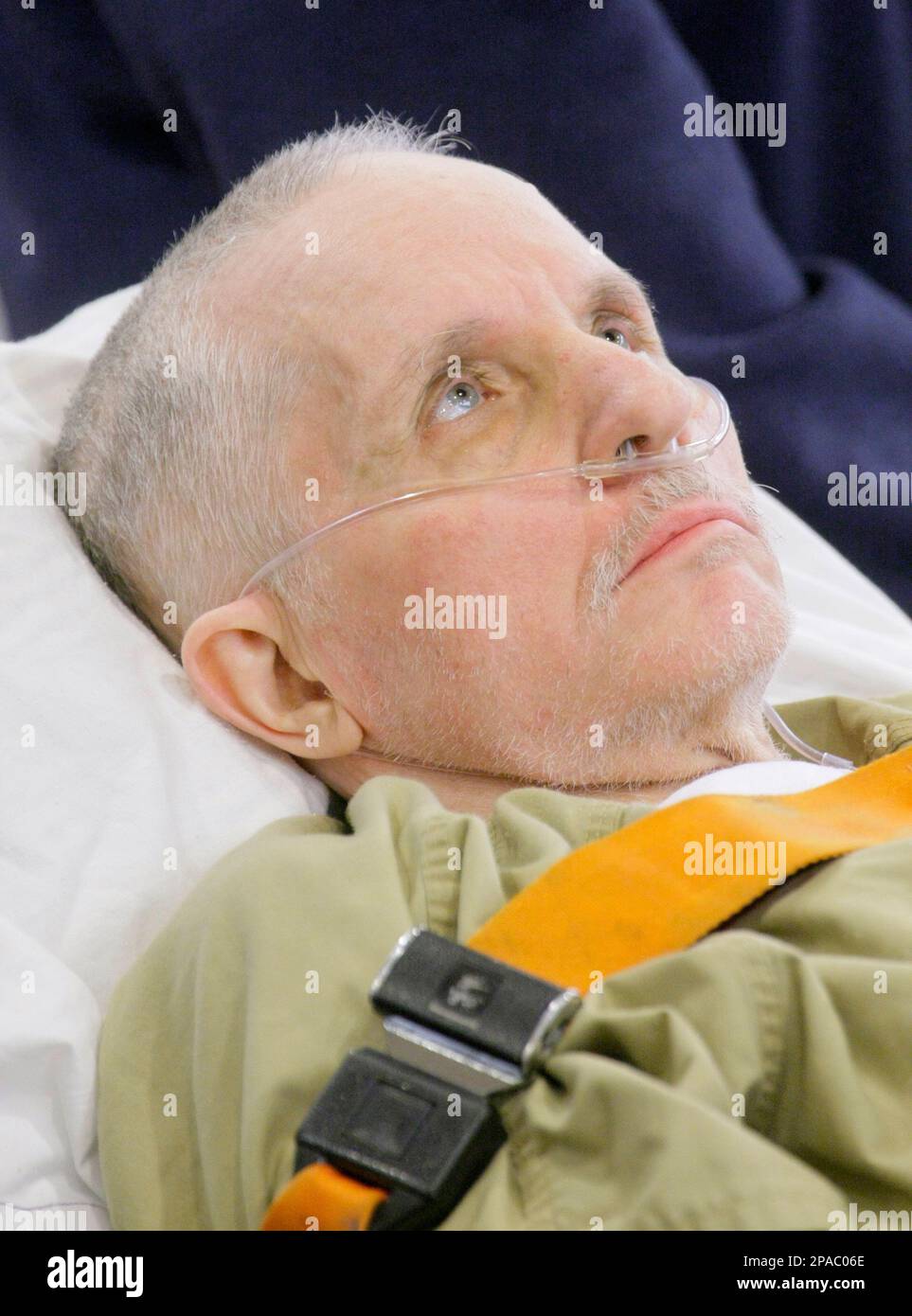 Strapped to a gurney and breathing oxygen, Robert Zarinsky looks up to ...