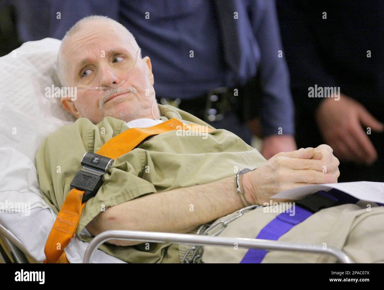 Handcuffed, strapped to a gurney and breathing oxygen, Robert Zarinsky ...