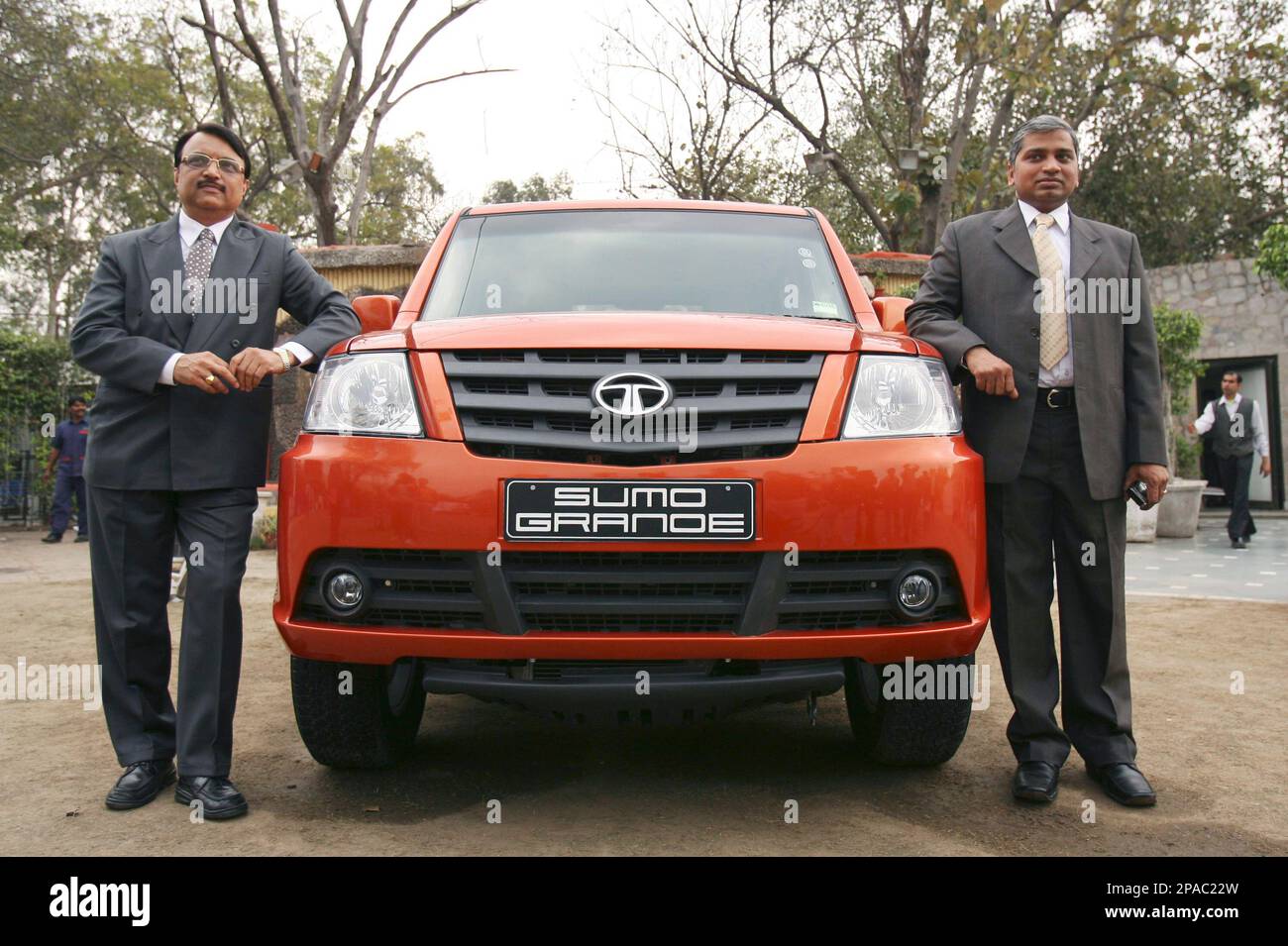 Tata Motors' S.G Saxena, left, and Jalaj Gupta pose for photographs with the new Sumo Grande ...