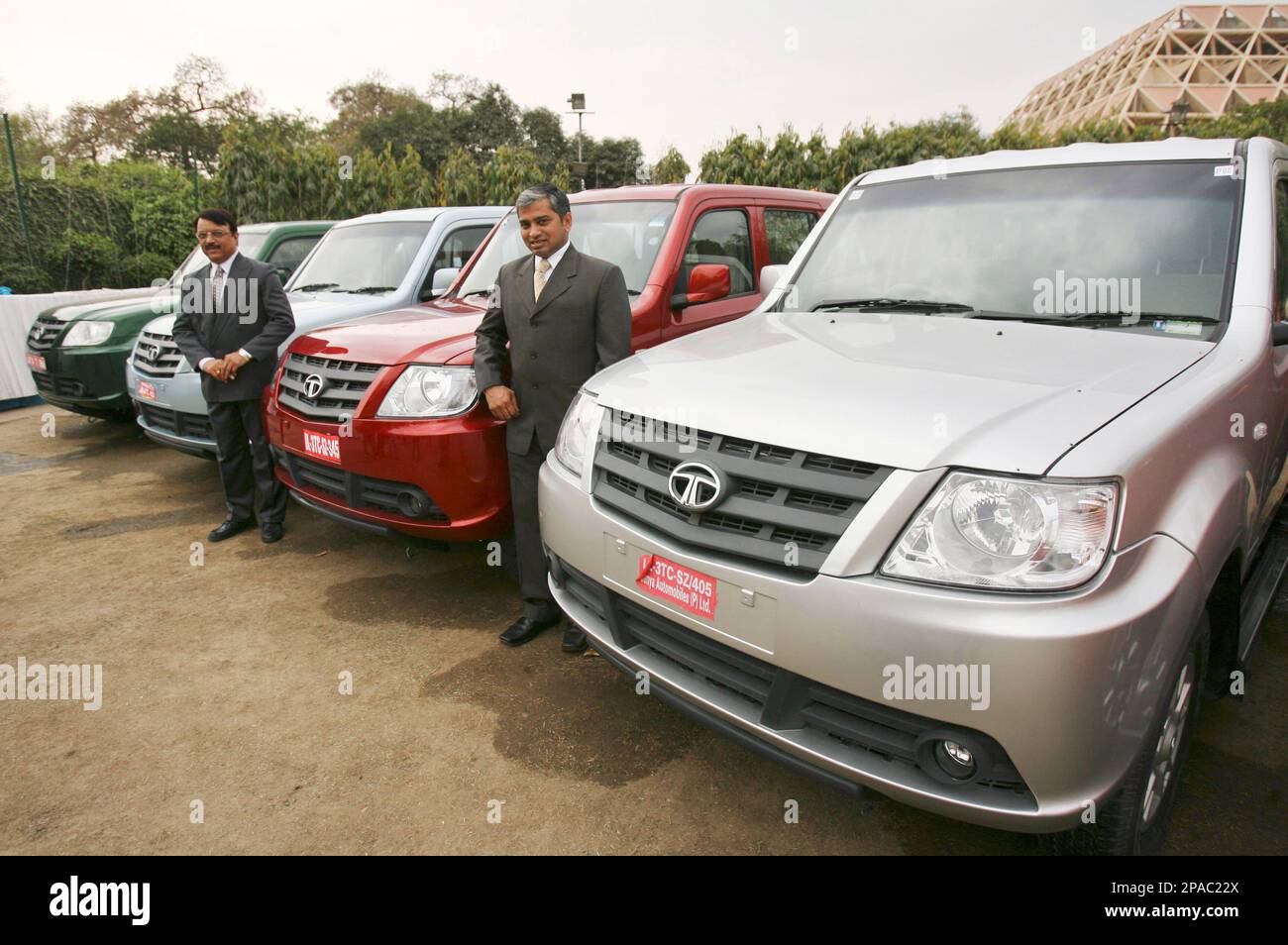 Tata Motors' S.G Saxena, left, and Jalaj Gupta pose for photographs with the new Sumo Grande ...