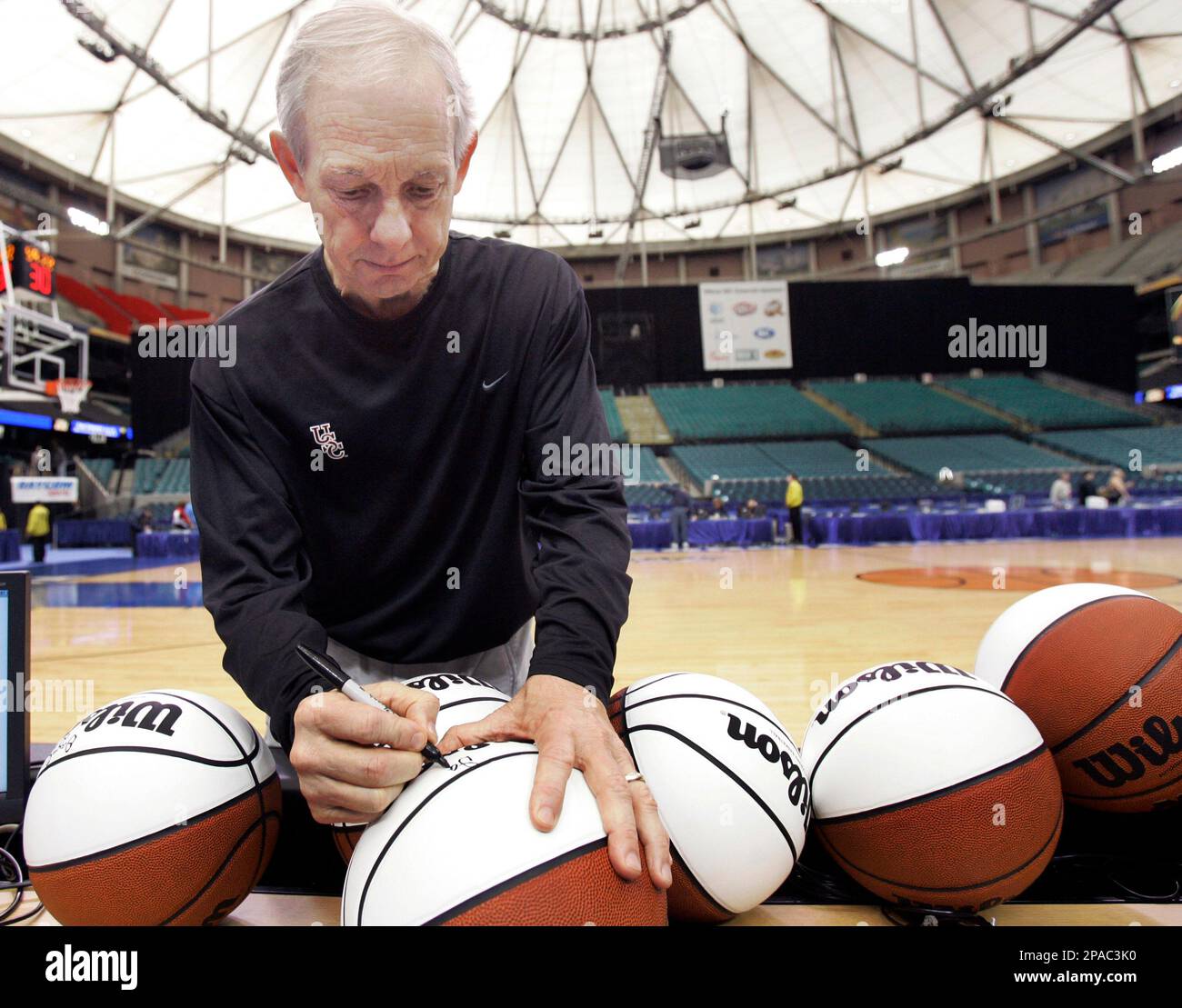 South Carolina coach Dave Odom signs a basketball after a practice ...