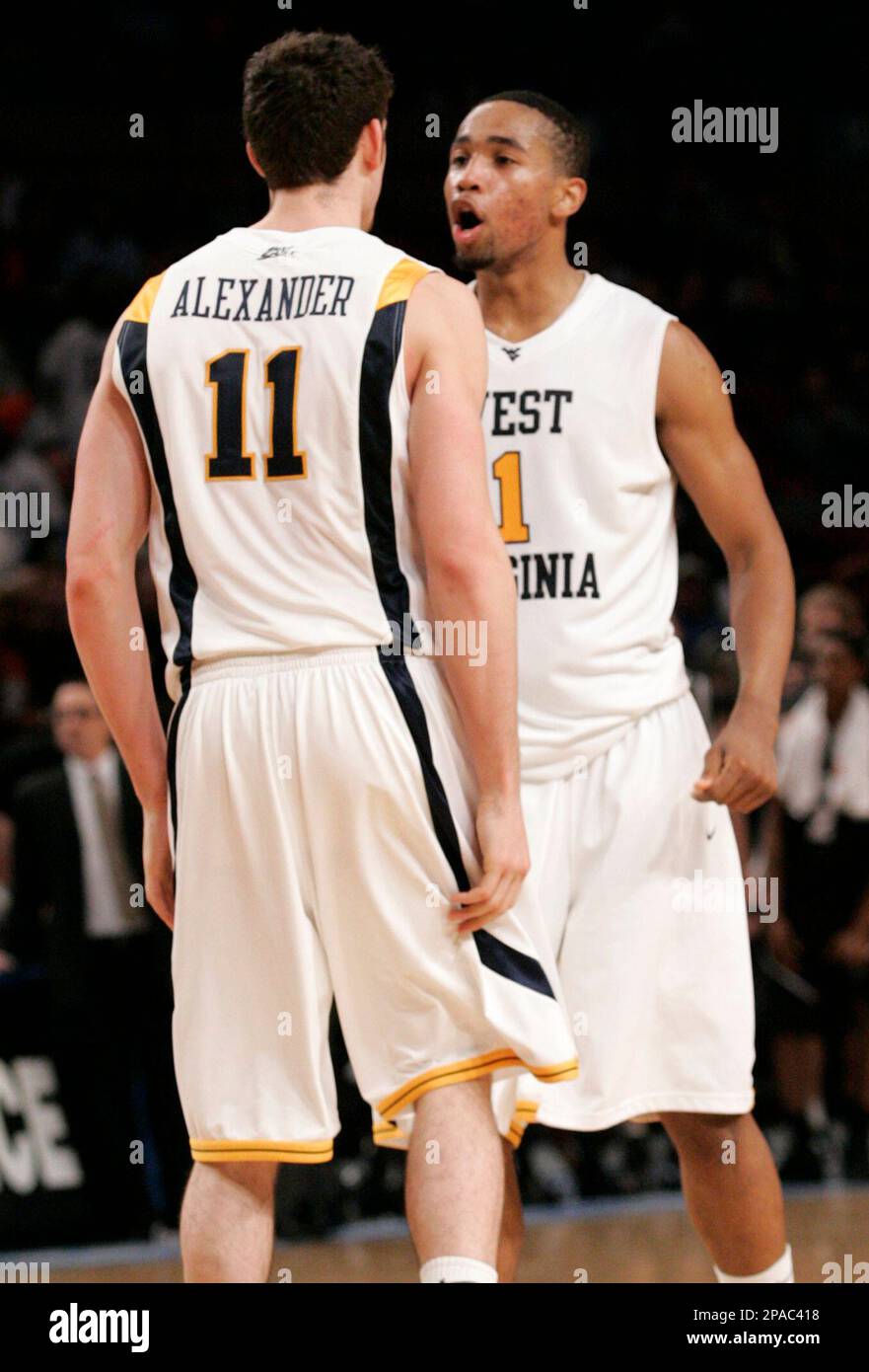 West Virginia's Joe Alexander (11) celebrates with Da'Sean Butler (1 ...