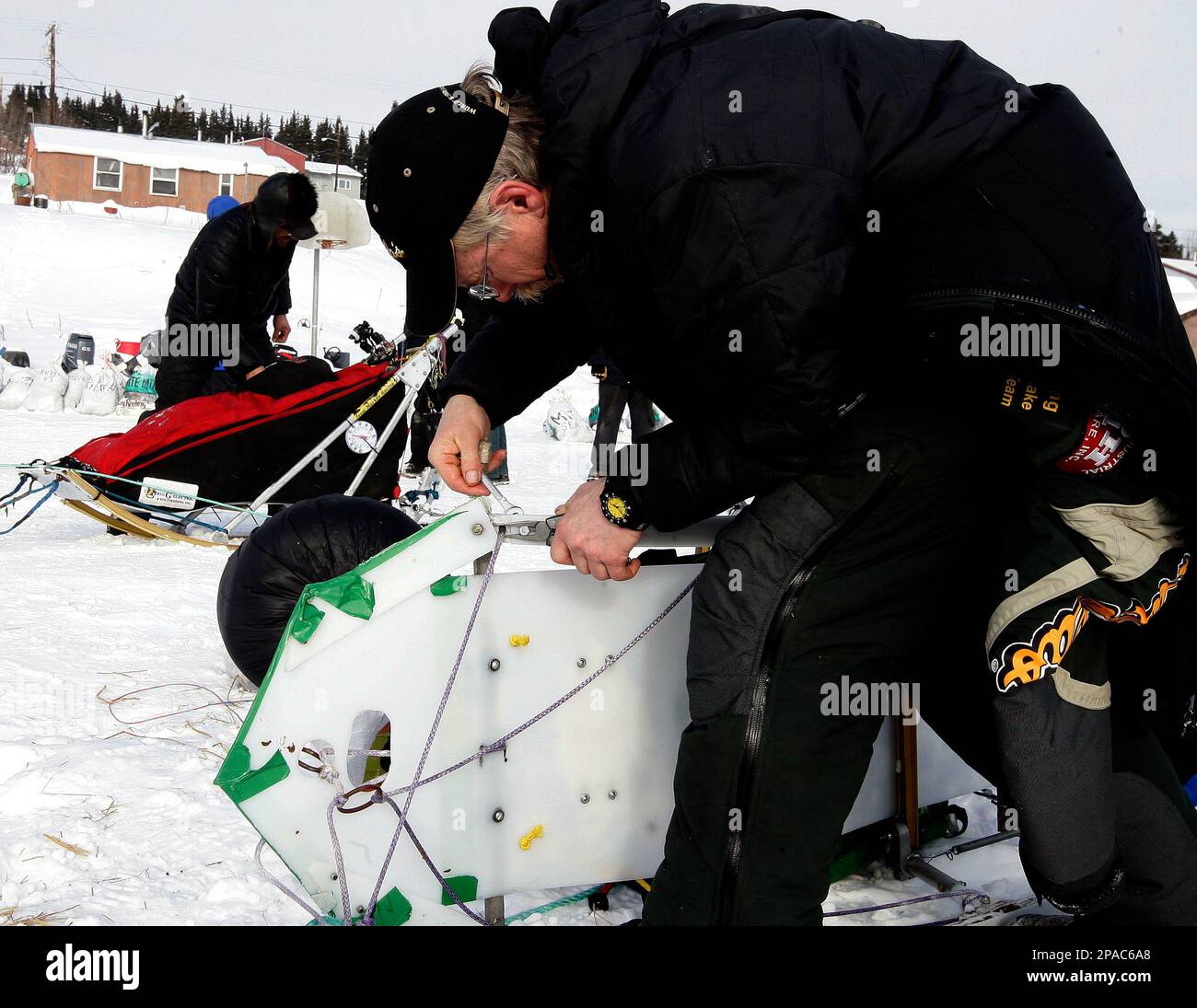 Four-time Iditarod champion Jeff King, right, repalces the runners on ...