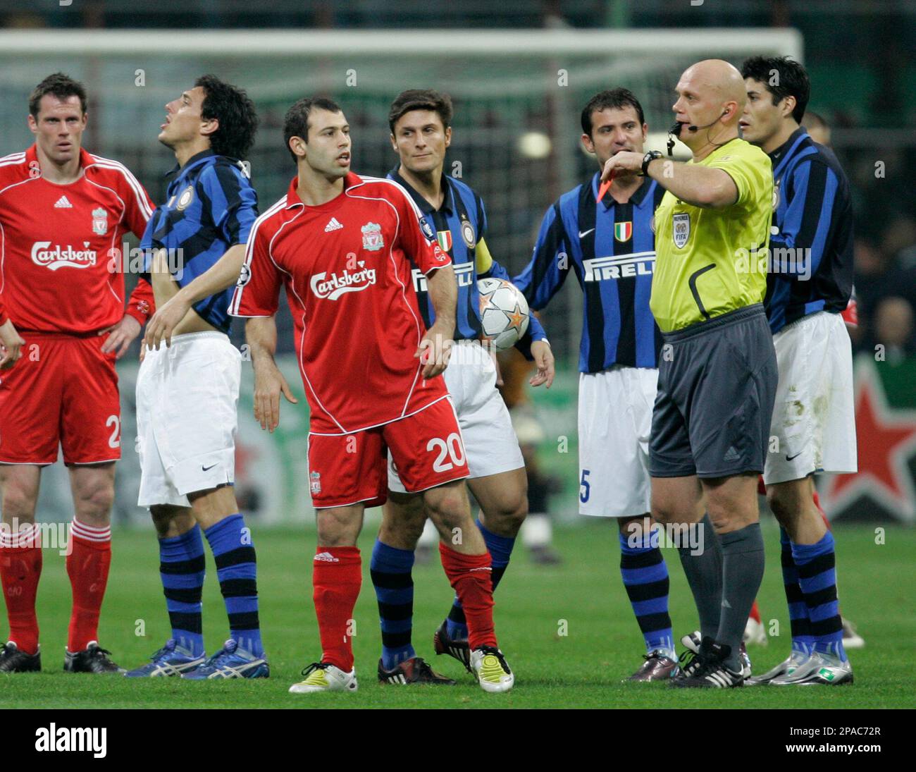Referee Tom Henning Ovrebo, in yellow jersey, gives the red card to ...