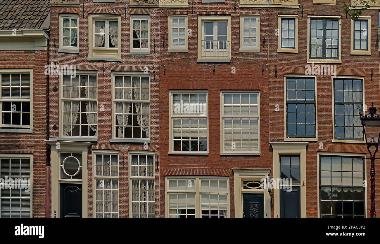 Closed doors and windows on traditional Amsterdam architecture building ...