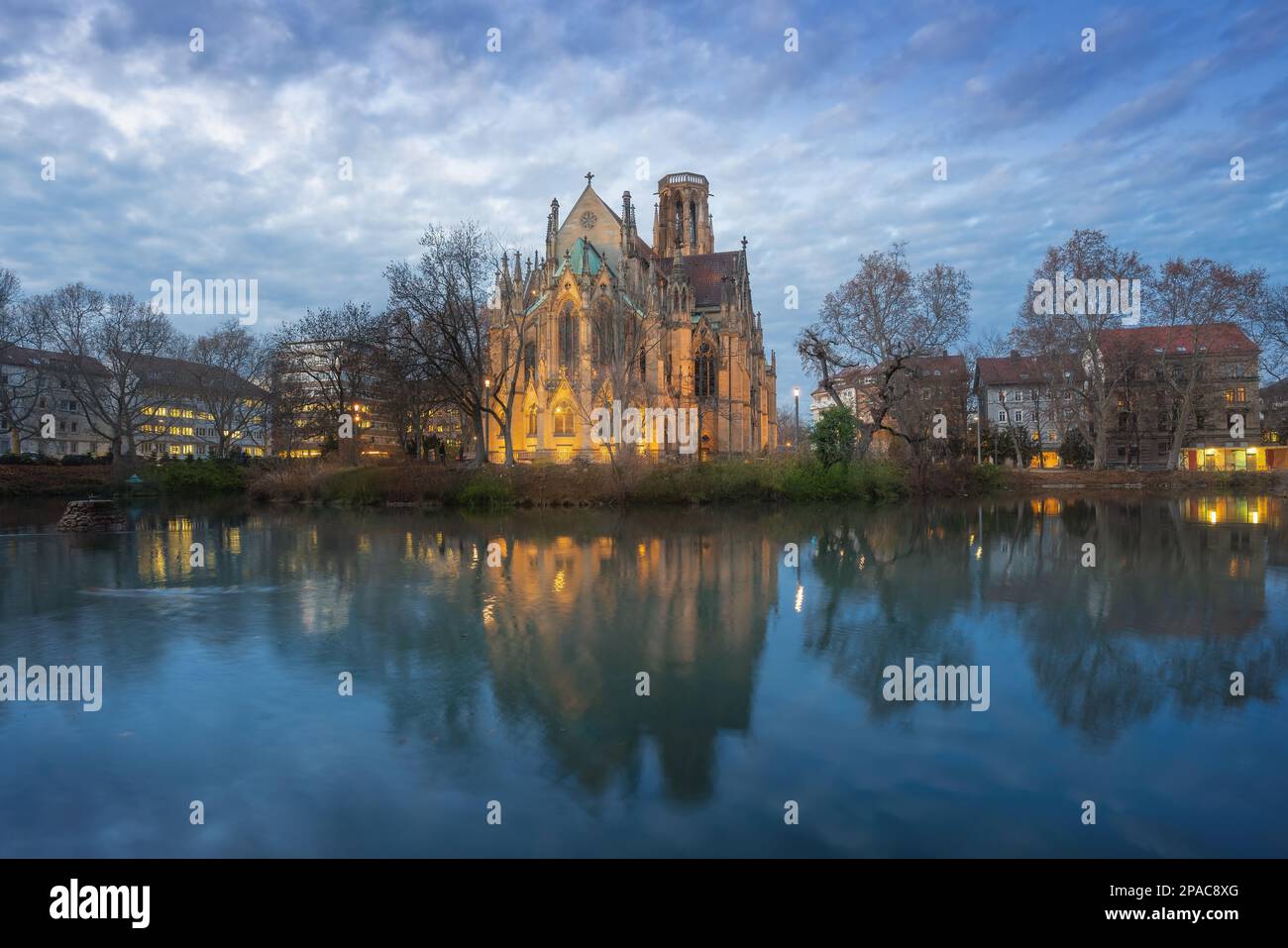 Illuminated St. John Church (Johanneskirche) at Feuersee lake ...