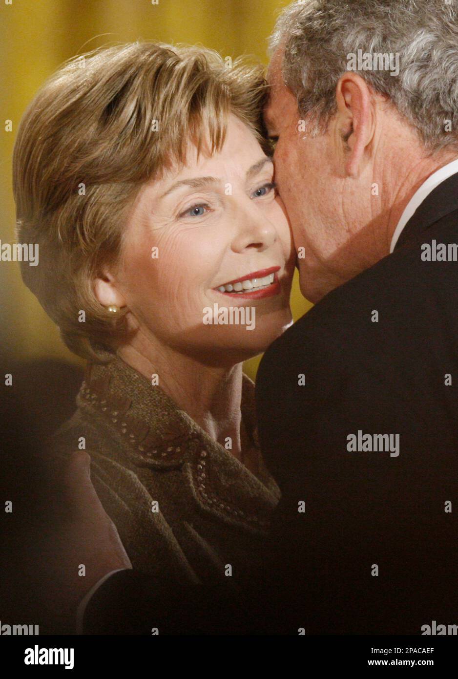 President Bush embraces first lady Laura Bush after she introduced him ...