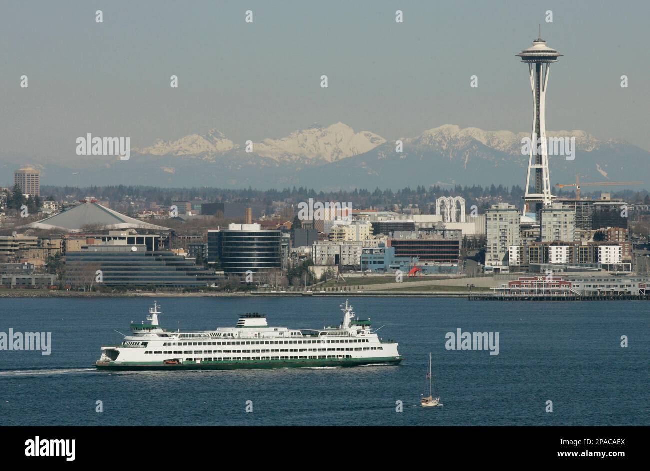 A Washington state ferry passes the Space Needle and a view of the ...