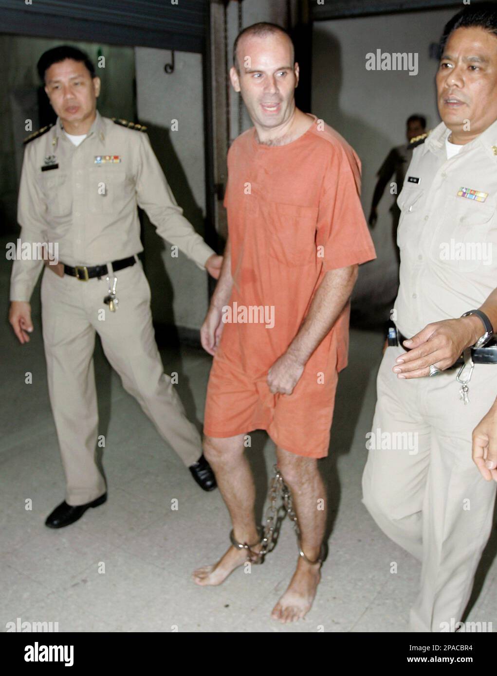 Canadian pedophile suspect Christopher Paul Neil, center, walks with ...